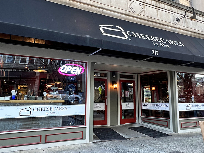 The navy blue awning of Cheesecakes by Alex beckons like a dessert lighthouse on Greensboro's Elm Street, promising sweet salvation for the sugar-deprived.