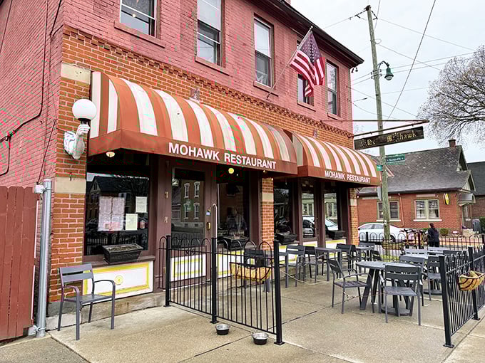 The iconic red brick and striped awning of The Old Mohawk stands as a beacon of comfort in Columbus' German Village. A neighborhood landmark that promises good times inside.