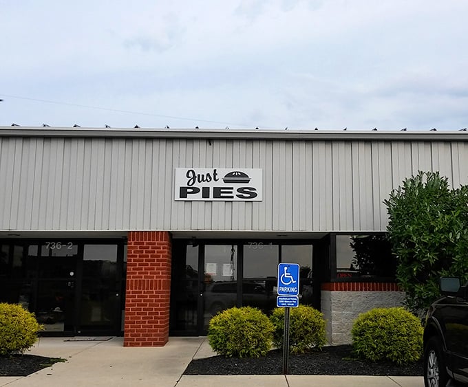 The unassuming exterior of Just Pies proves once again that culinary greatness rarely comes with flashy packaging.