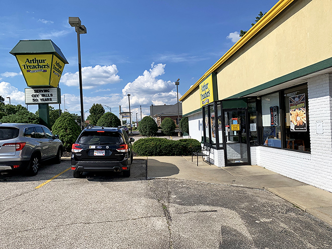 The iconic yellow and green sign stands like a lighthouse for fish and chips enthusiasts, beckoning hungry travelers to this rare surviving Arthur Treacher's outpost.