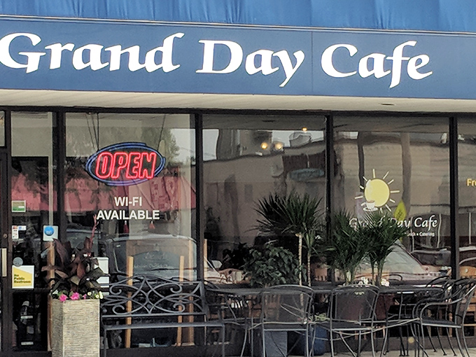 The blue awning of Grand Day Cafe beckons like a breakfast lighthouse guiding hungry souls to hash brown paradise. 