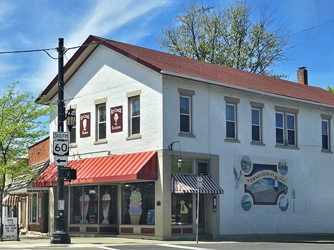 The white brick building with its cherry-red awning stands like a time capsule on Vermilion's corner, promising sweet nostalgia inside.