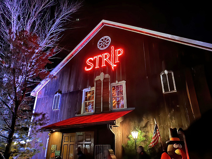 The glowing red neon against weathered barn wood creates the perfect first impression. Like a beacon for carnivores, Strip Steakhouse's exterior promises rustic elegance within. 