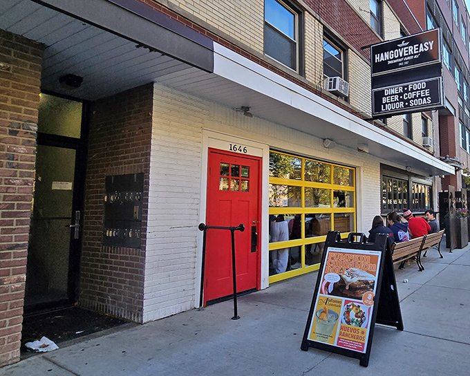 The iconic red door and yellow windows of HangOverEasy stand out like a beacon of breakfast hope on Neil Avenue. Morning salvation awaits inside.