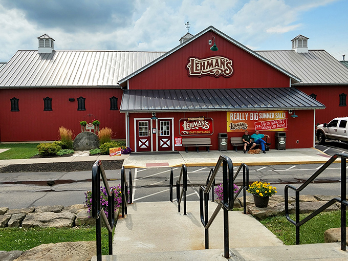The iconic red barn exterior of Lehman's stands like a beacon of nostalgia against the Ohio sky, promising treasures that time hasn't forgotten.