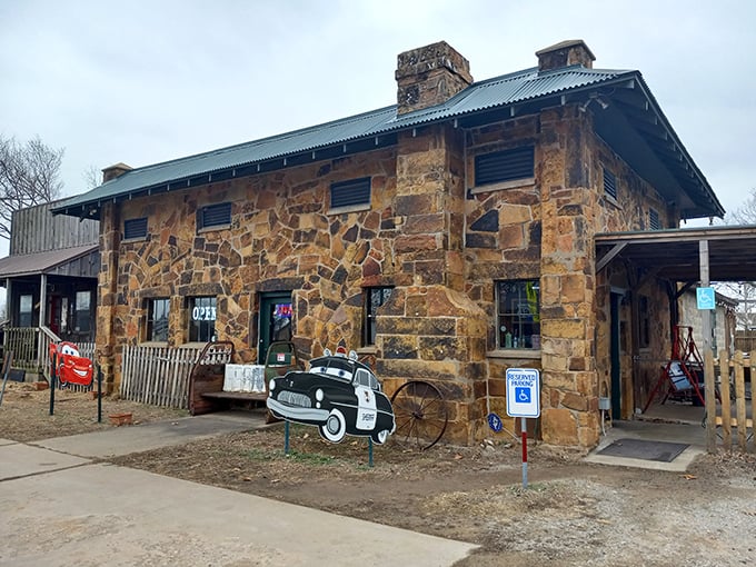 The iconic stone exterior of Rock Cafe stands as a Route 66 sentinel, complete with vintage car cutouts that practically wink at passing travelers.