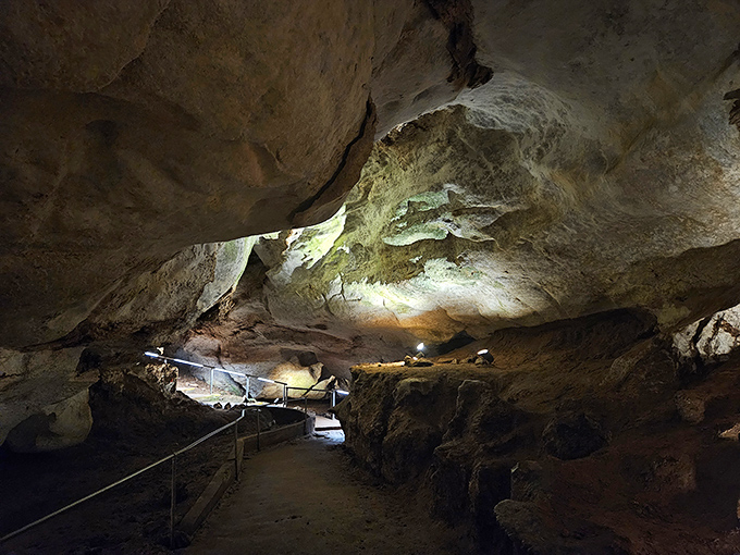 Nature's own cathedral awaits below ground. The dramatic lighting transforms ancient alabaster formations into a subterranean art gallery millions of years in the making.