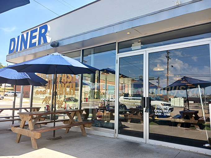 The iconic blue "DINER" sign beckons like a lighthouse for the breakfast-starved, promising all-day comfort in the heart of OKC.