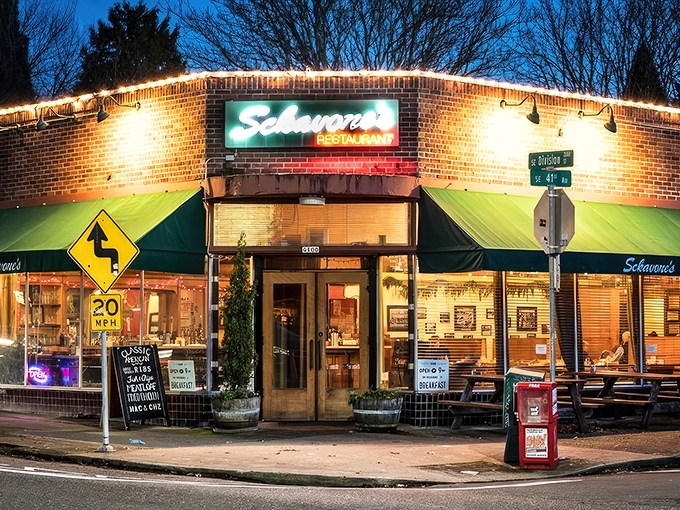 The corner brick building glows like a lighthouse for hungry souls, its green awnings and twinkling lights promising comfort on even the dreariest Portland evening.