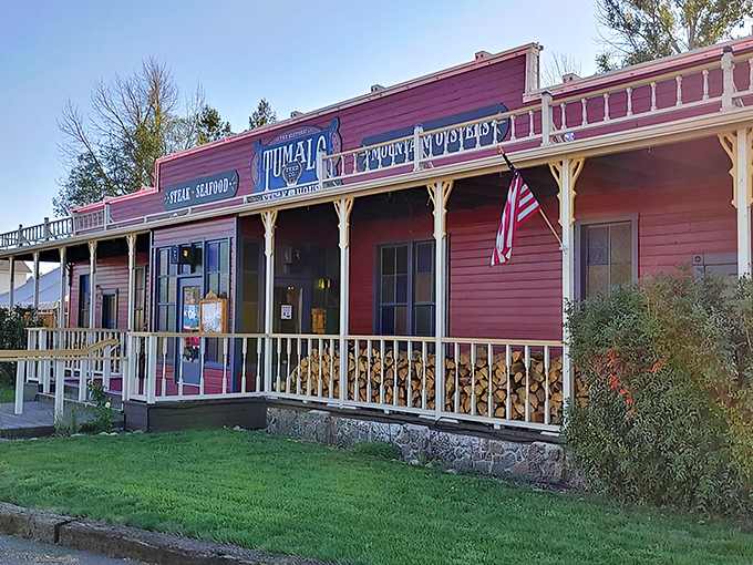 The iconic red facade of Tumalo Feed Co. stands proudly against the Oregon sky, a rustic time machine beckoning hungry travelers with its Western charm and promise of carnivorous delights.