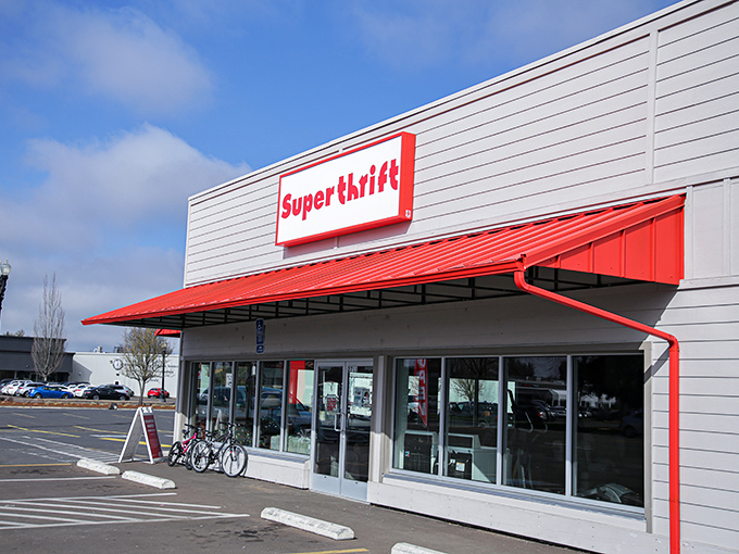 The bold red awning of SuperThrift stands out like a beacon for bargain hunters, promising treasures within its unassuming exterior.