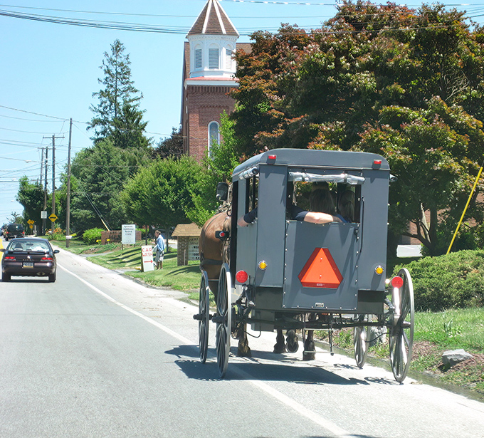 The classic Amish buggy against a church backdrop isn't just transportation&mdash;it's a moving postcard of a simpler time that somehow feels right at home in 2023.