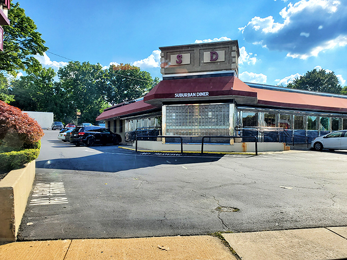 The iconic Suburban Diner sign promises "BAKING ON PREMIS" &ndash; a charming typo that somehow makes the anticipation of fresh-baked goods even more endearing. 