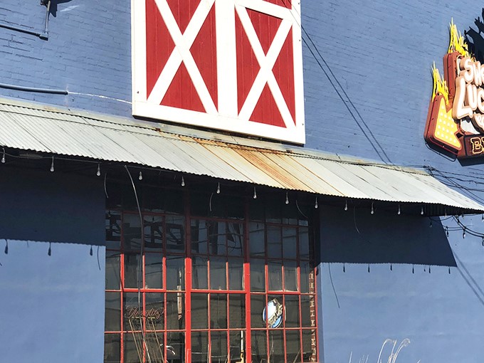 The blue exterior with its red barn door isn't trying to impress anyone&mdash;until you smell what's happening inside. BBQ paradise awaits.