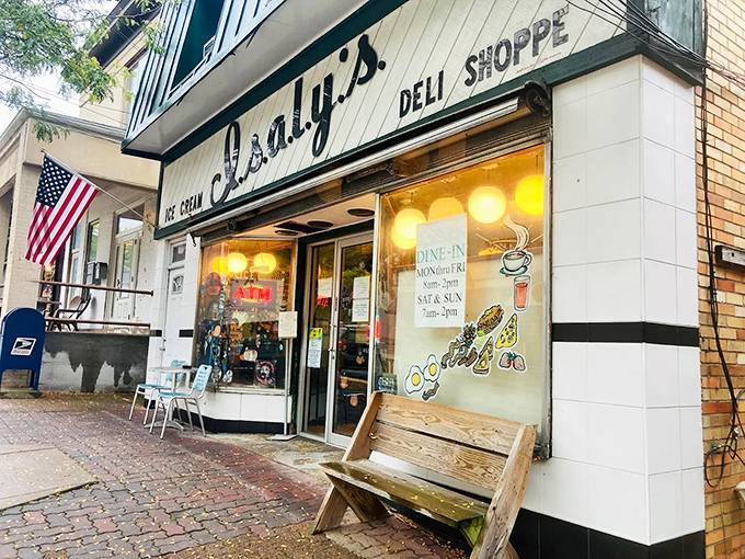 The classic storefront beckons like an old friend, complete with American flag and wooden bench &ndash; nostalgia served daily alongside the chipped ham.
