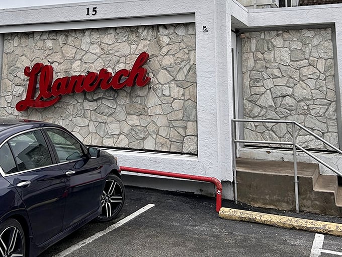 The iconic stone facade of Llanerch Diner stands like a culinary lighthouse, beckoning hungry travelers with its classic red signage and timeless charm.