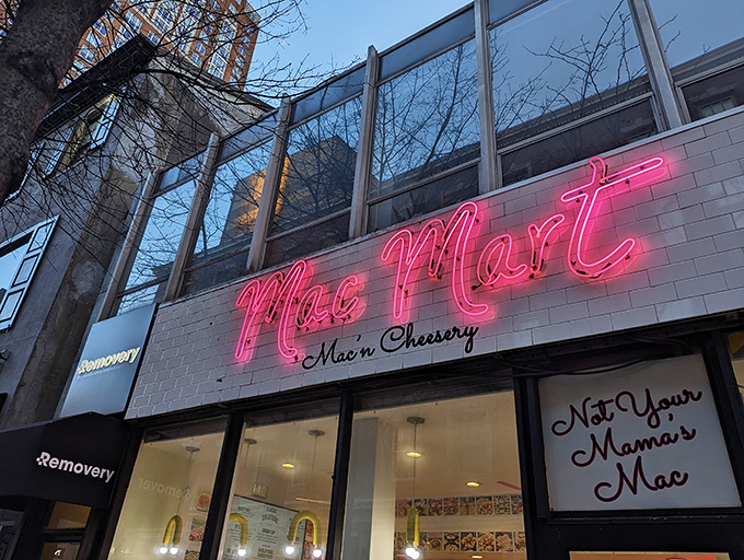 The pink and white storefront beckons like a cheesy lighthouse, with those sunny yellow chairs promising a comfort food adventure ahead.