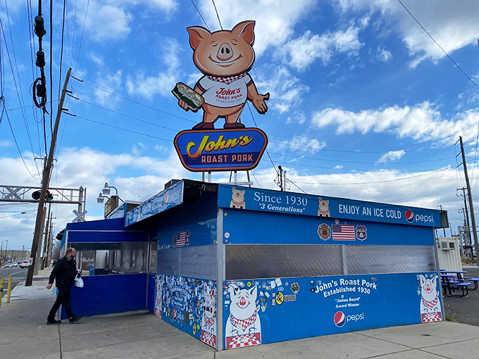 The bright blue beacon of sandwich salvation stands proudly in South Philly, its cartoon pig mascot practically winking at hungry pilgrims.