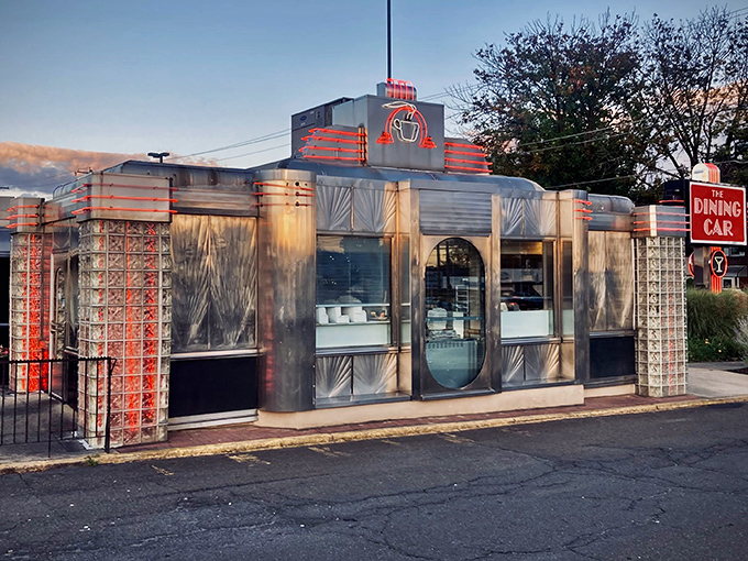 Gleaming in the sunset glow, The Dining Car's classic stainless steel exterior promises a time-traveling culinary adventure that begins before you even step inside.