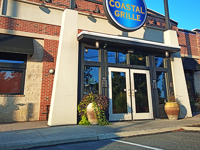 The blue sign beckons like a lighthouse for hungry travelers. Coastal Grille's welcoming entrance promises seafood salvation in suburban Wyomissing.