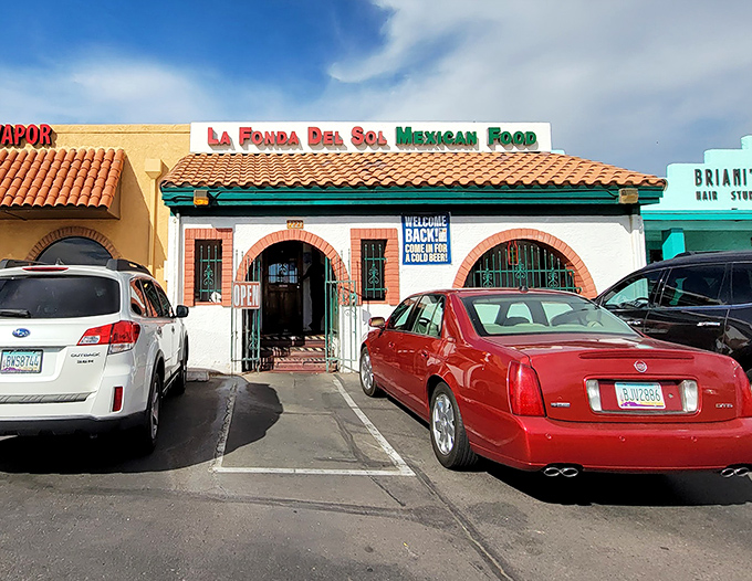 The iconic terra cotta roof and vibrant red-and-green signage of La Fonda Del Sol promises authentic Mexican flavors before you even step inside.