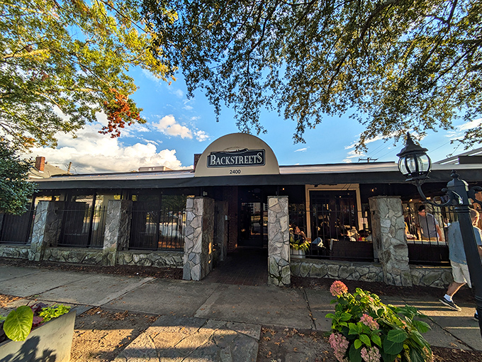 The stone facade of Backstreets Grill welcomes hungry travelers like an old friend who knows exactly what you need after a long day.