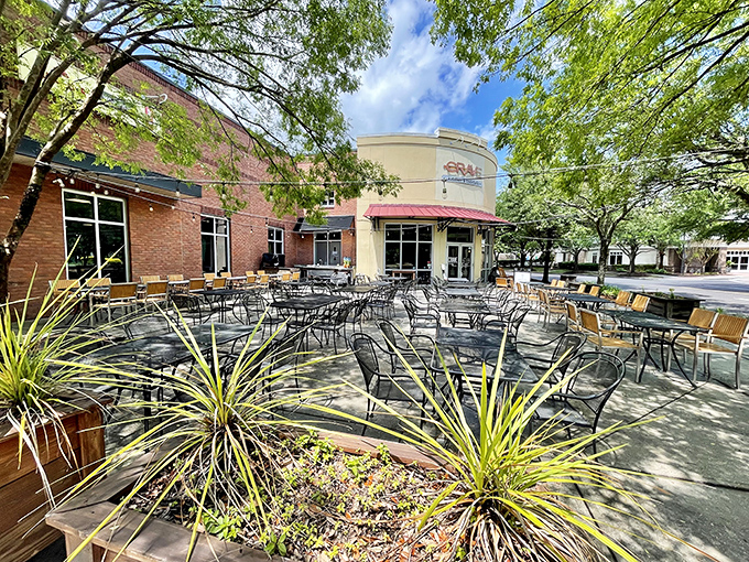 The curved facade of Crave beckons like a cheesy siren call. Those red umbrellas promise refuge from both sun and boring meals.