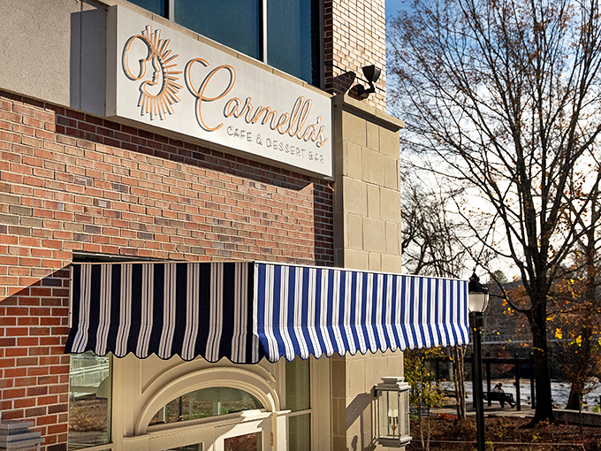 Carmella's elegant storefront glows like a beacon for dessert lovers, with its classic black and white awnings promising sweet sophistication inside.