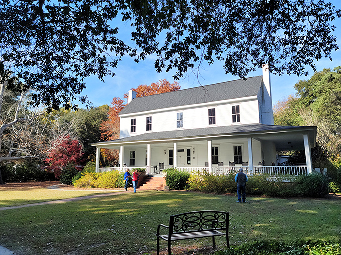 The Thomas E. Hart House stands like a Southern gentleman in a white suit, welcoming visitors with its classic wraparound porch and timeless charm.
