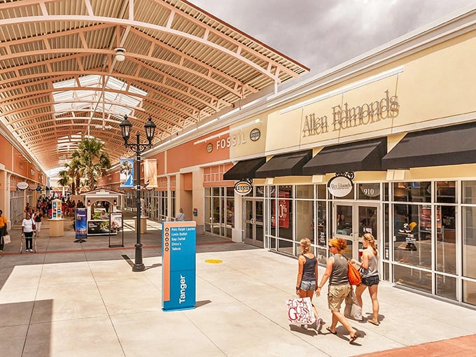 Palm trees frame the Charleston-inspired architecture of Tanger Outlets, where fountains and storefronts create a shopping oasis that feels more resort than retail.