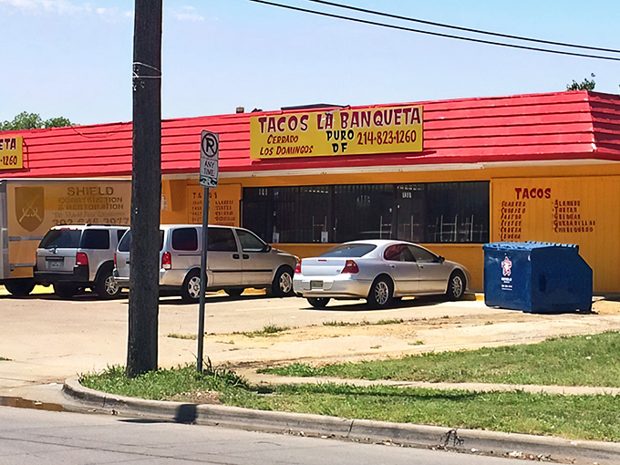 The bright red exterior of Tacos La Banqueta stands out like a beacon of hope for hungry travelers. No fancy architecture needed when the food speaks this loudly.