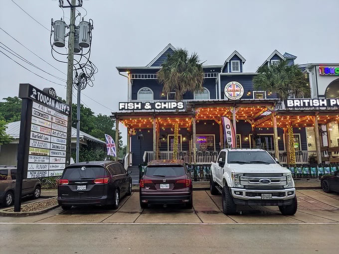 The blue facade of Fish and Chips Houston stands proudly in Kemah, where palm trees and Union Jacks create the most delightful cultural collision since tea met Texas.