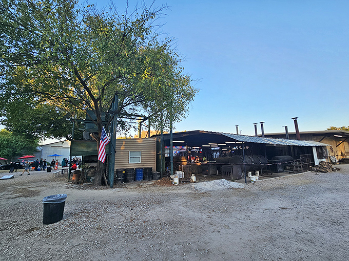The pilgrimage begins here &ndash; rustic smokers, weathered wood, and that iconic water tower standing like a barbecue lighthouse guiding hungry souls home.