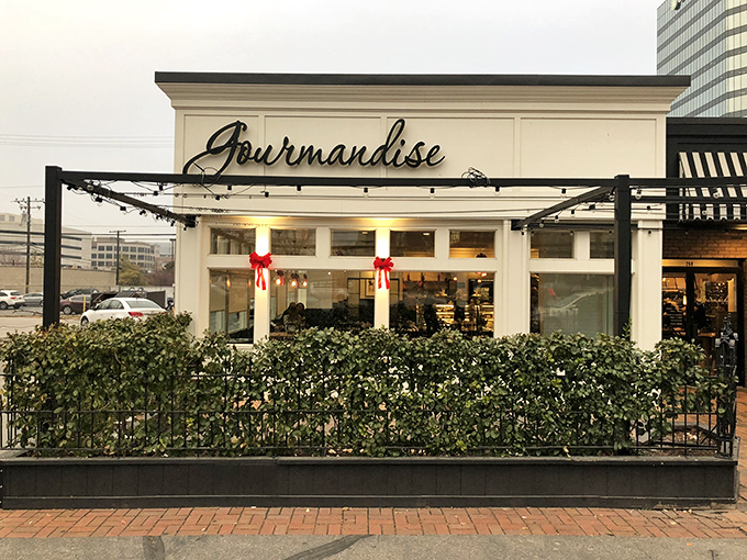 Gourmandise's charming exterior with vibrant red awnings and hanging flower baskets creates an instant European escape in downtown Salt Lake City.
