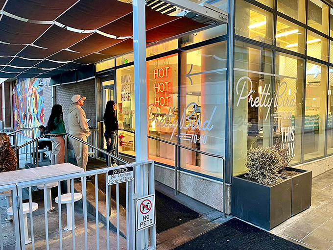 The "BAWK APPETIT HERE" sign says it all&mdash;Pretty Bird's storefront promises chicken nirvana with a side of clever wordplay.