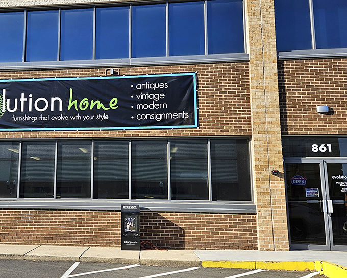 The unassuming brick exterior of Evolution Home hides a universe of treasures within, like a speakeasy for furniture enthusiasts.