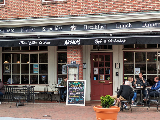 The classic brick fa&ccedil;ade of Aromas welcomes visitors with the promise of caffeine and comfort, a beacon of culinary delight in historic Williamsburg.