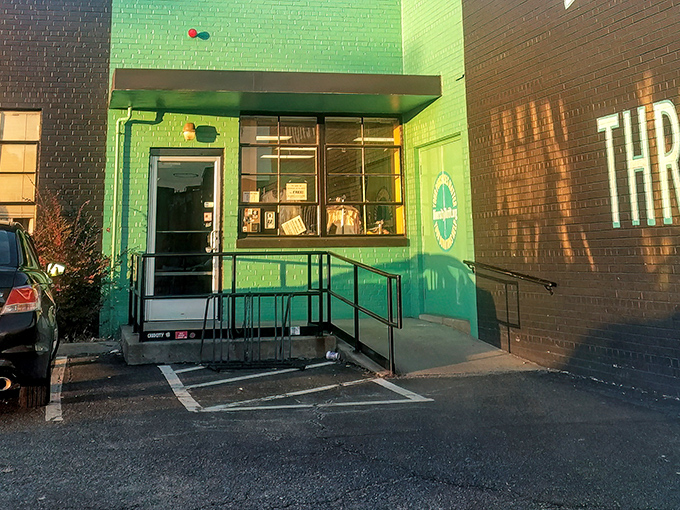 The unmistakable lime-green entrance to Diversity Thrift stands like a beacon for bargain hunters, promising treasures within its unassuming brick walls.