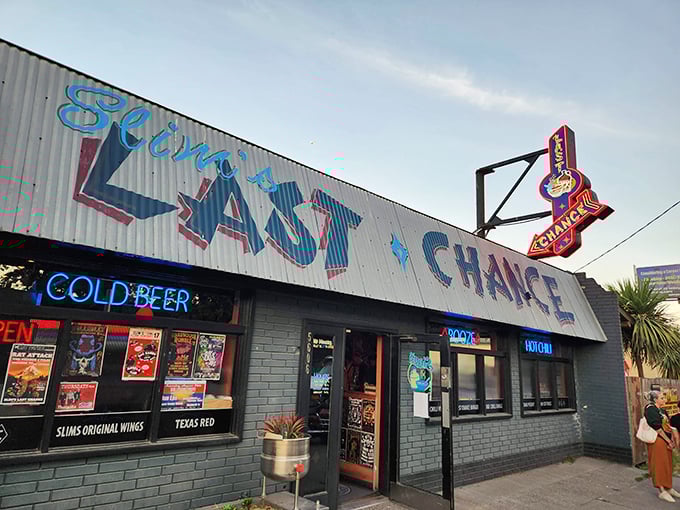 The neon-lit promise of "Slim's Last Chance" beckons like a honky-tonk mirage in Seattle's industrial landscape. Cold beer awaits inside this unassuming chili paradise.