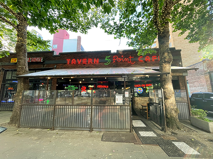 The 5 Point's iconic brick exterior and neon signage beckons like an old friend, promising comfort food and zero pretension in Seattle's bustling Belltown neighborhood.