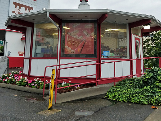 The iconic pink Almond Roca sign stands like a beacon of sweetness against the blue Tacoma sky, promising delicious treasures within.