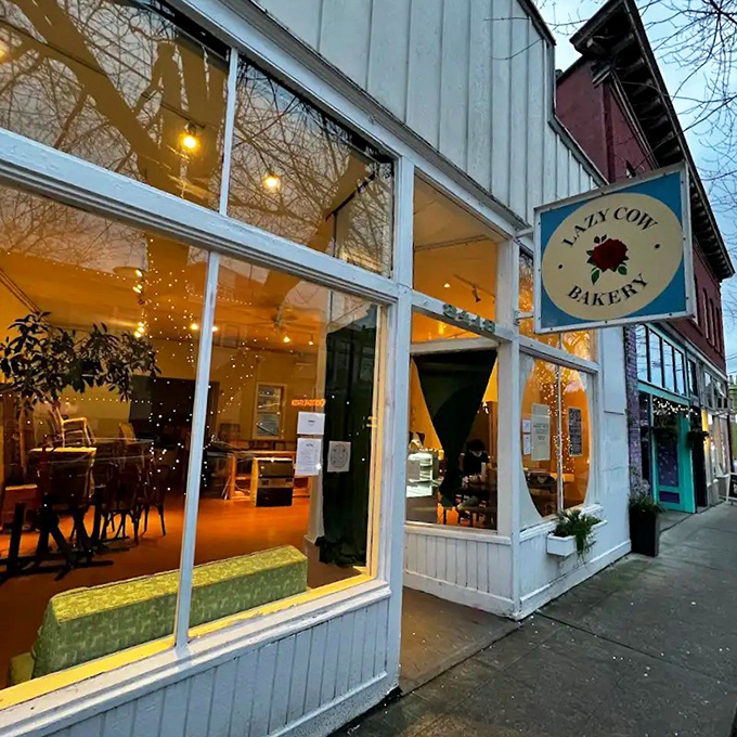 The unassuming white exterior of Lazy Cow Bakery proves once again that Seattle's best culinary treasures often hide in plain sight, no neon required.