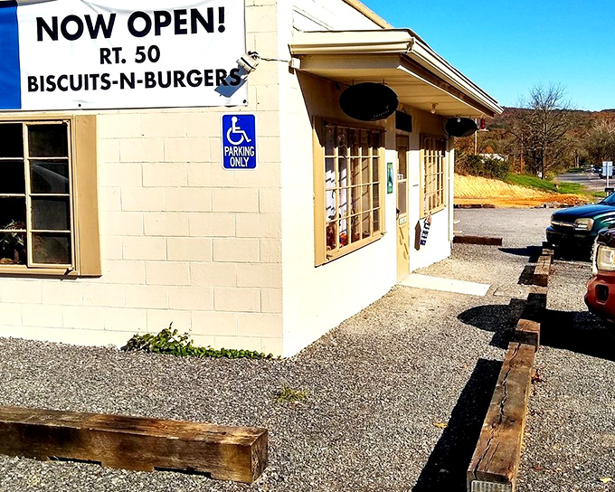 The humble exterior of Rt.50 Biscuits & Burgers glows with promise at dusk, string lights beckoning hungry travelers like a culinary lighthouse in Romney.