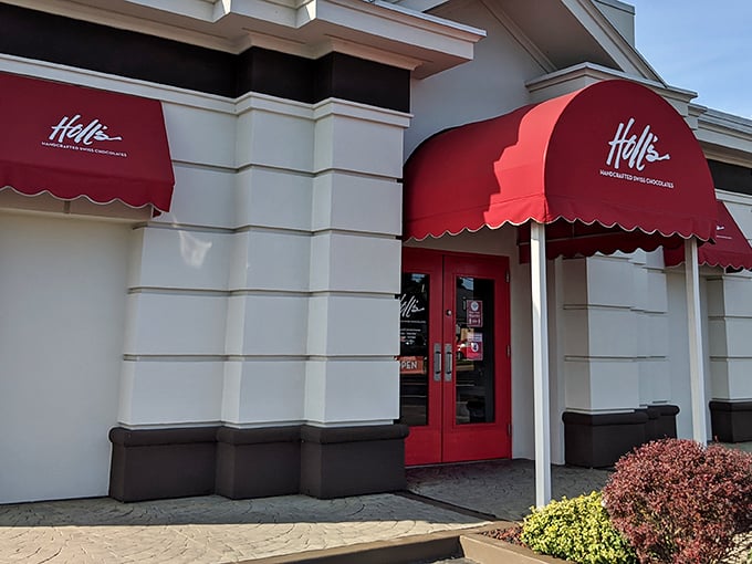 The iconic red awning of Holl's beckons chocolate lovers like a Swiss flag signaling delicious neutrality in the battle against willpower.