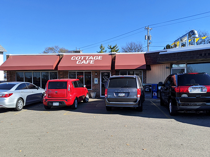 The coral-colored awnings of Cottage Cafe stand like beacons of breakfast hope against Madison's skyline, promising comfort food salvation to hungry travelers.