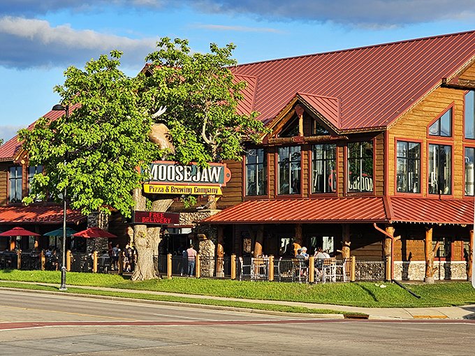 The log cabin palace of pizza rises from the Wisconsin landscape like Paul Bunyan's dream retirement home, complete with a watchful moose guardian.