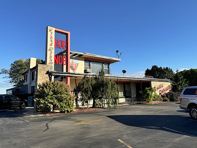 That iconic red neon sign beckons like an old friend, promising a night of culinary nostalgia and Midwest hospitality at HOBNOB Restaurant.
