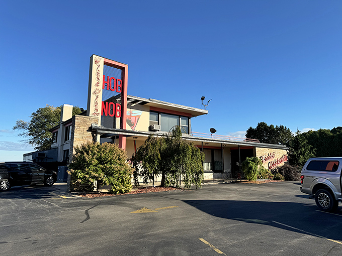 The iconic red HOBNOB sign stands tall against the Wisconsin sky, a beacon for prime rib pilgrims and supper club aficionados for generations.