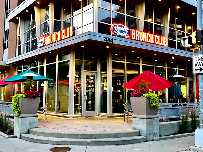 The corner entrance beckons like a brunch lighthouse, with those turquoise umbrellas promising a colorful escape from ordinary breakfast routines.
