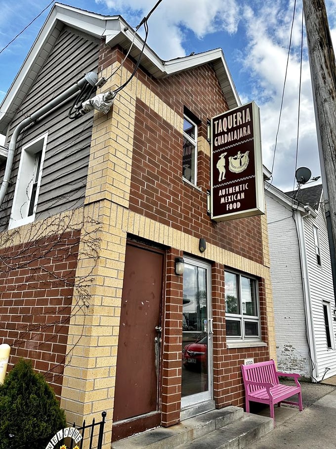 The unassuming brick exterior with that eye-catching pink bench is like a secret handshake &ndash; those who know, know this is where Madison's burrito magic happens.